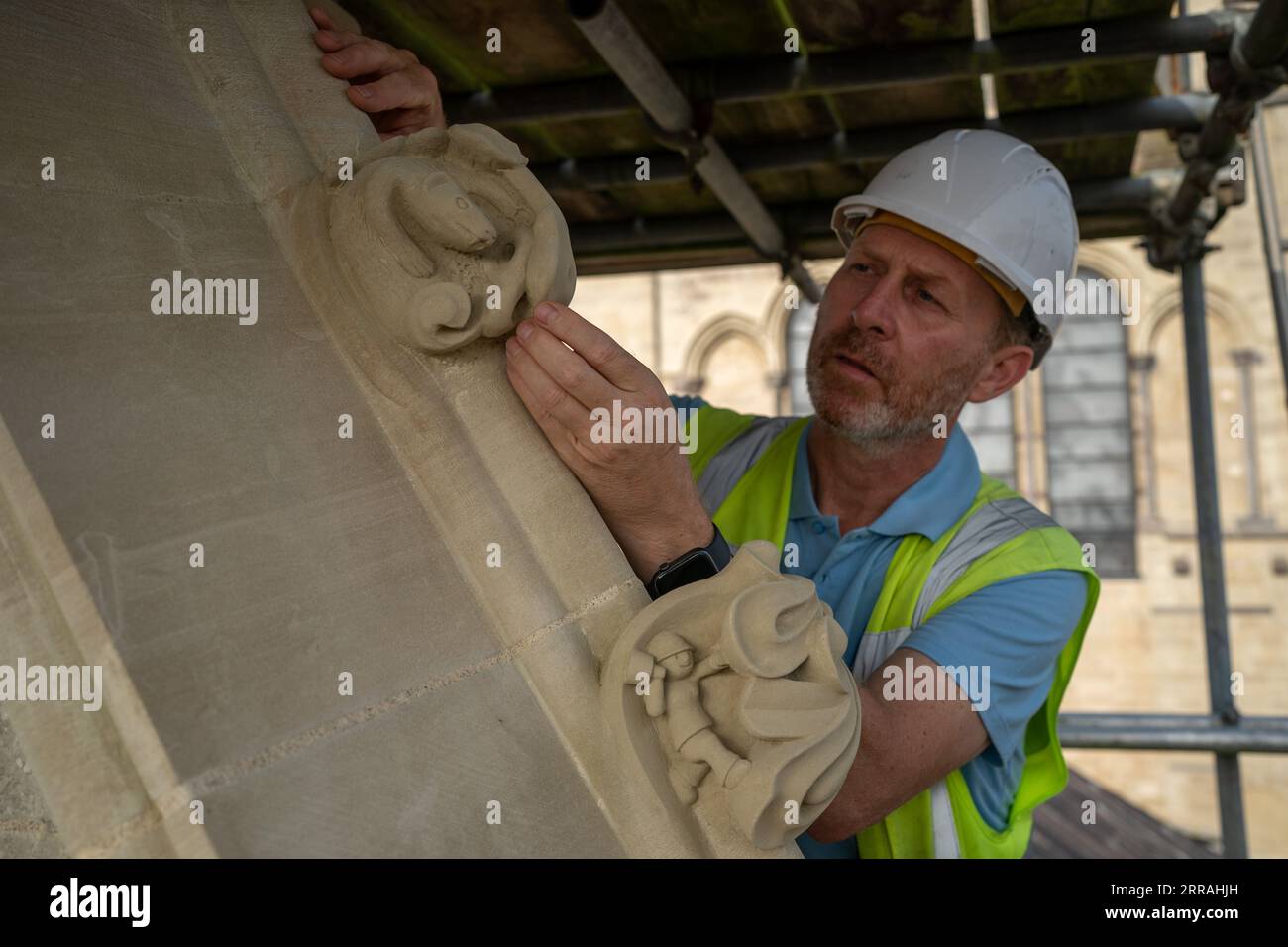 Clerk of works Gary Price inspects hidden creative figures carved into ...