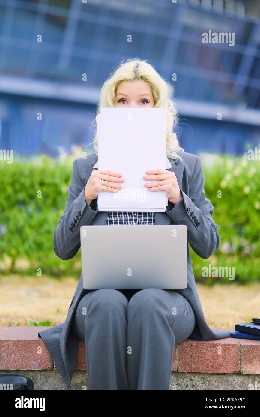 Girl hiding face behind paper hi-res stock photography and images - Alamy