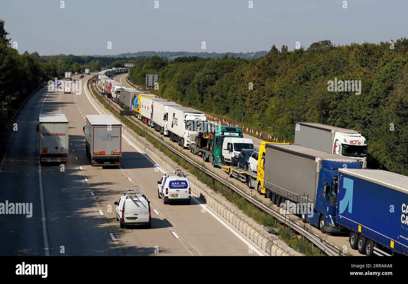 Lorries queue for the Port of Dover along the M20 near Ashford in Kent ...