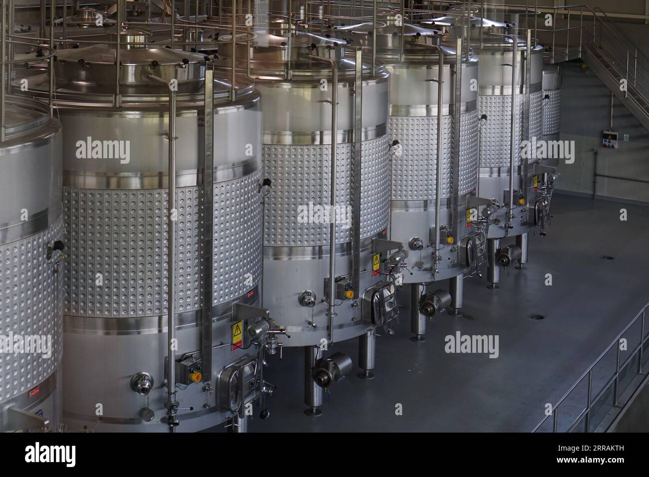 Modern stainless steel wine vats in winery interior Stock Photo - Alamy