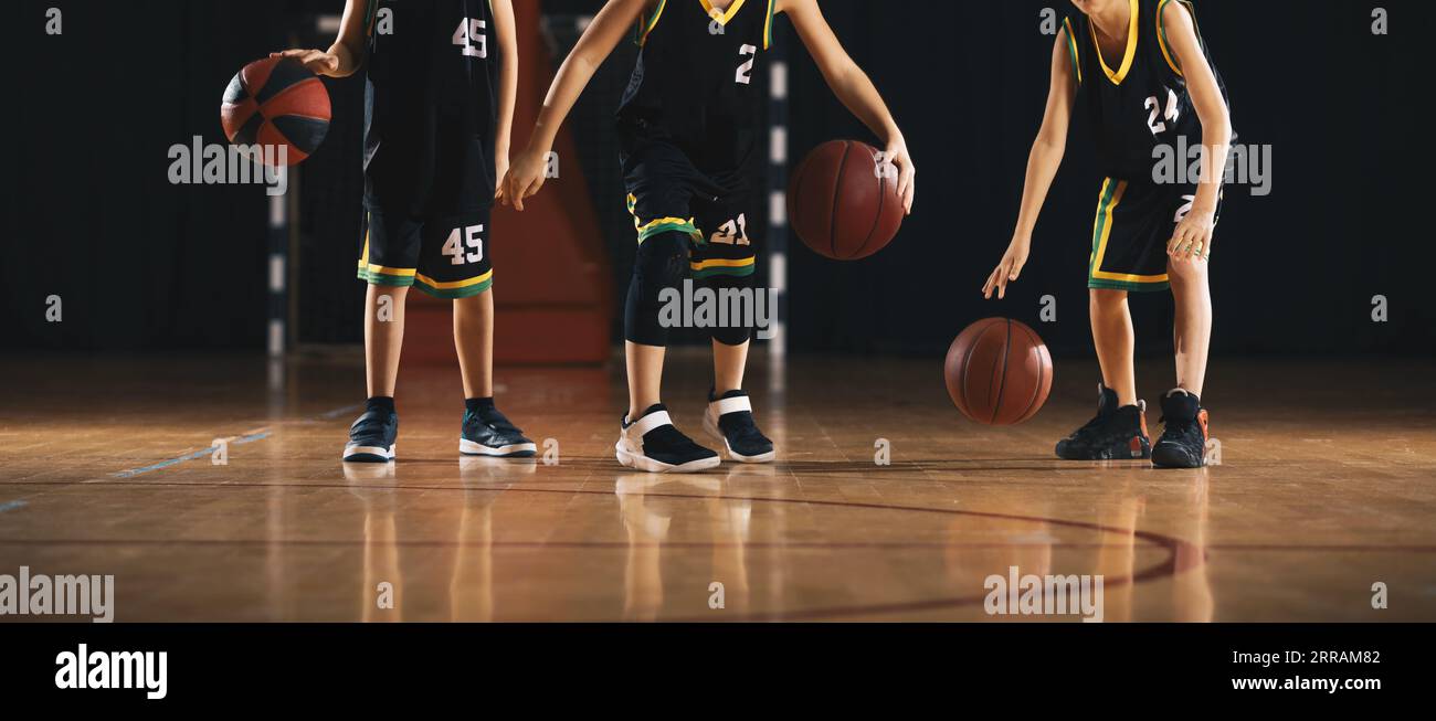 Group of kids bouncing basketball balls on a wooden court. Children on ...