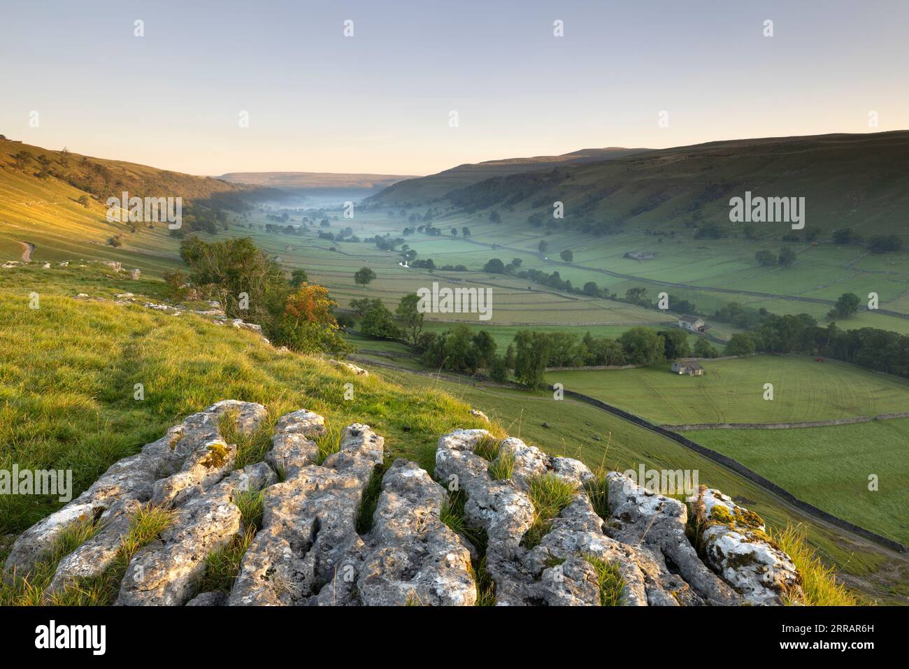 A misty morning view in the Yorkshire Dales, looking up the valley of ...