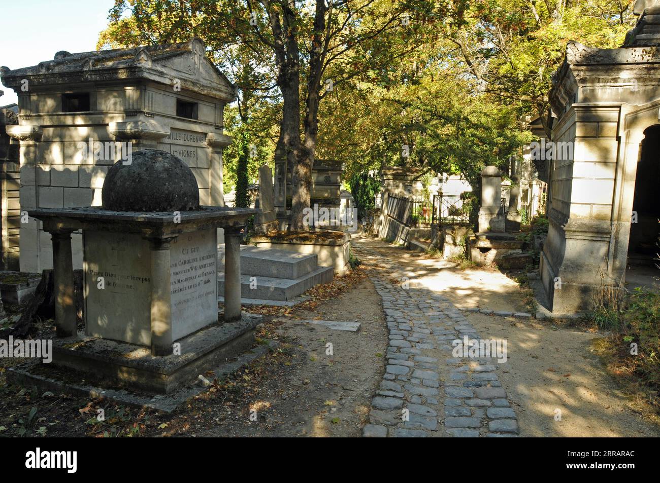 A cobblestone path leads past old tombs and grave sites in Paris ...