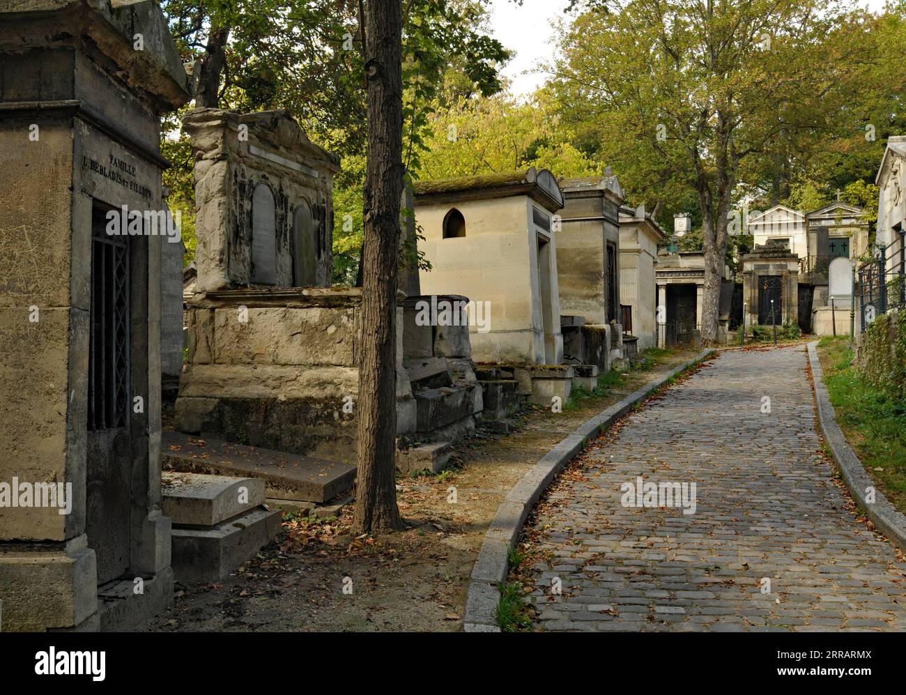 A stone path leads past old tombs and grave sites in Paris' historic ...