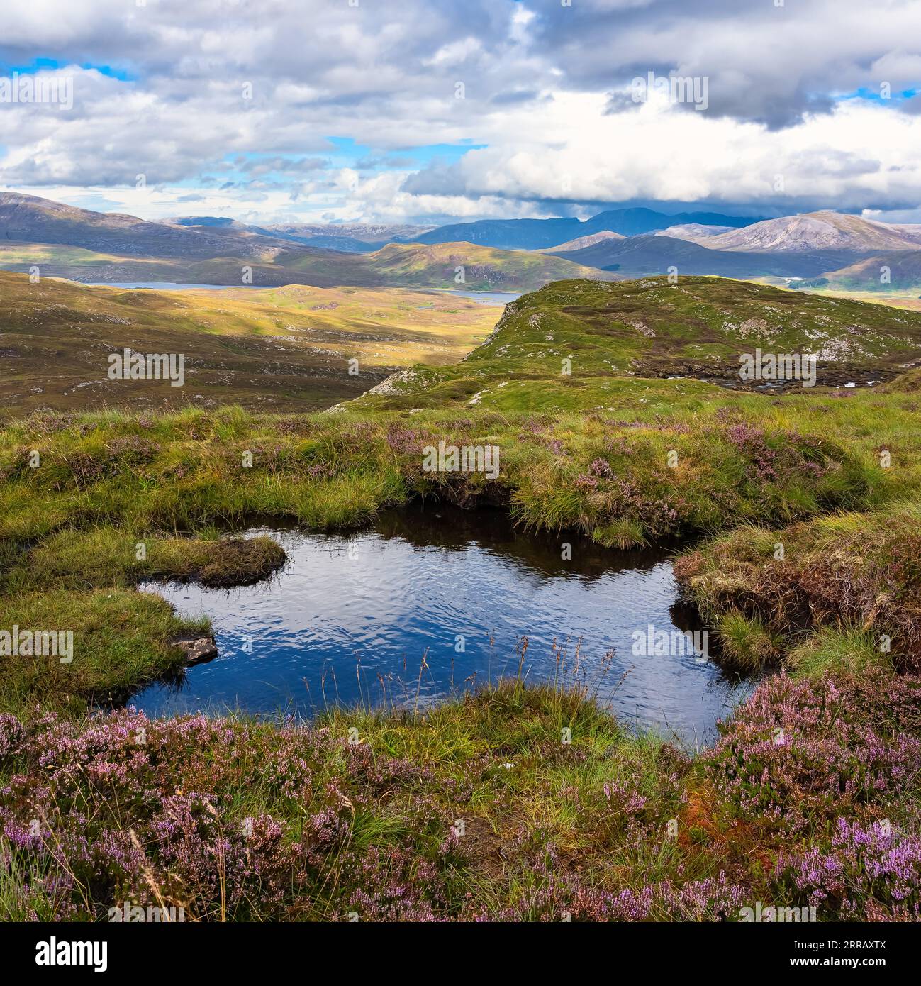 Small lake at the top of the green mountains near Ullapol, Scotland, UK ...
