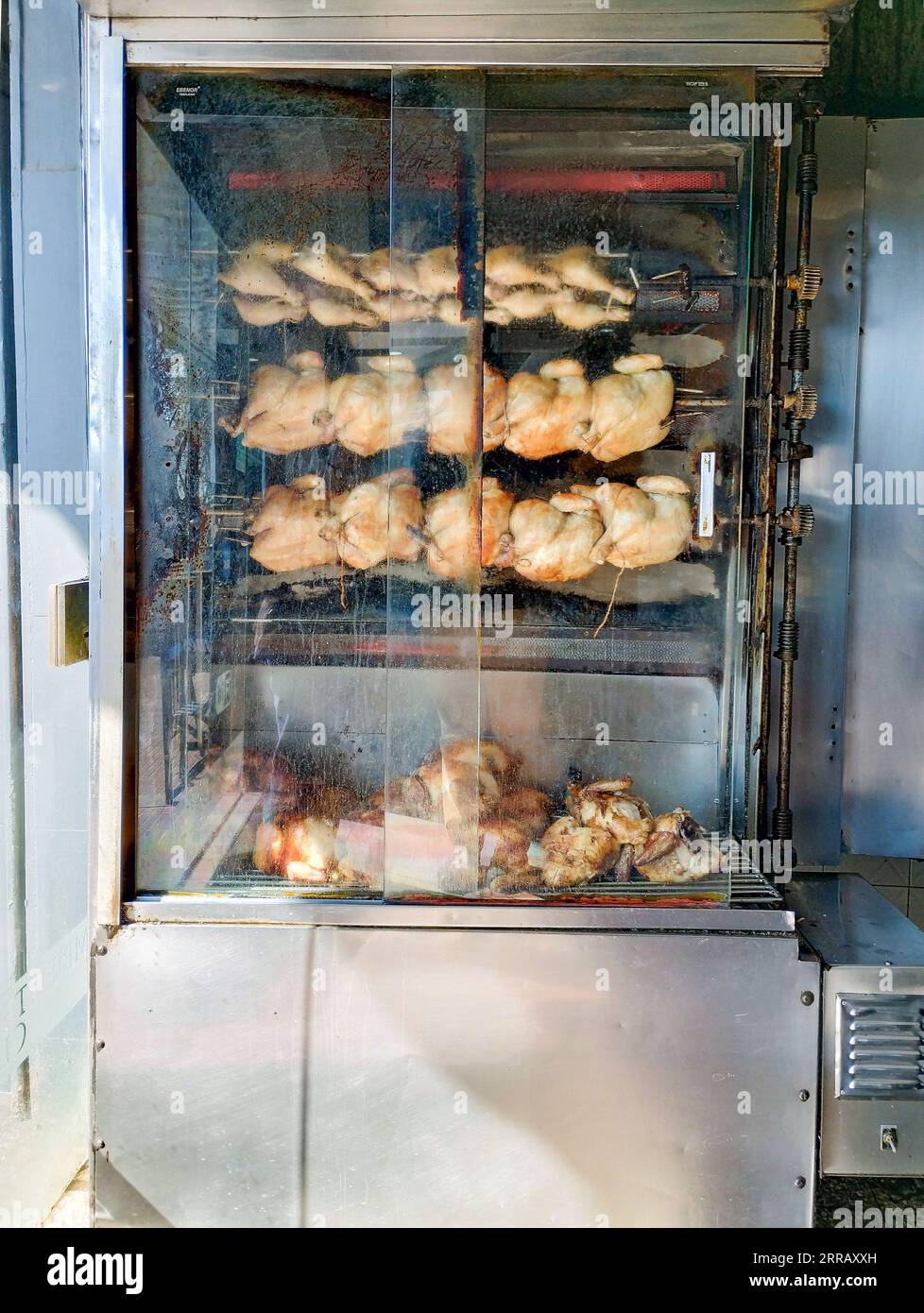 rotisserie chickens cooked in a spiedo oven Stock Photo - Alamy