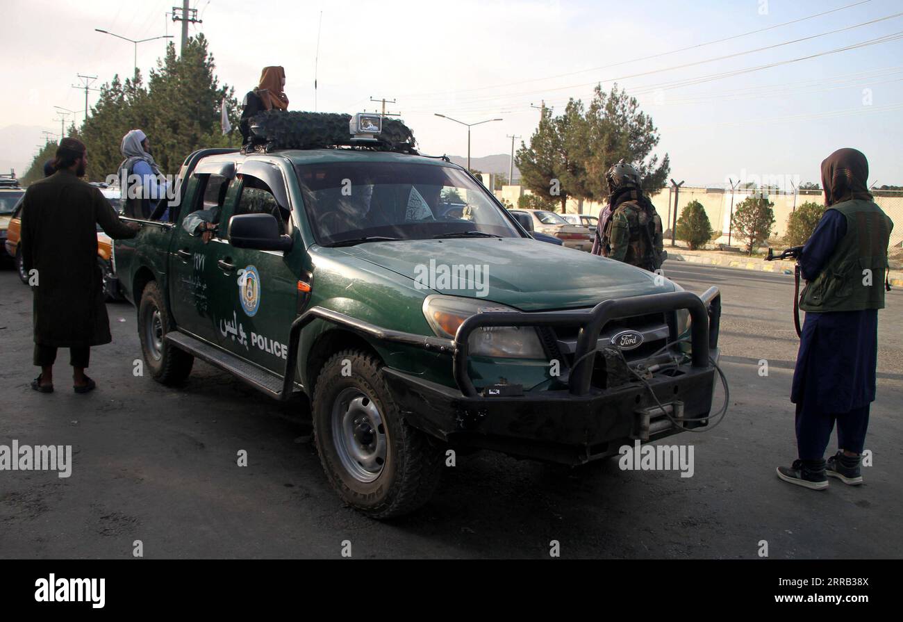 210829 -- KABUL, Aug. 29, 2021 -- Taliban fighters are seen on a road ...