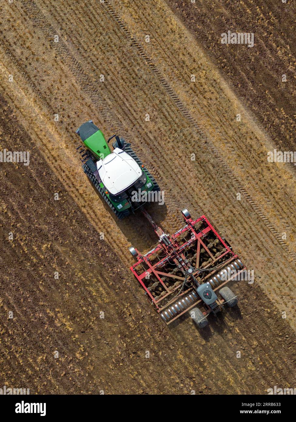 Aerial view of a farm vehicle working on farmland in North Yorkshire in ...