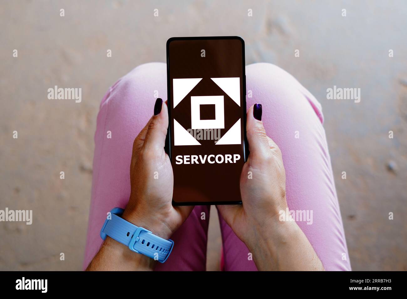 In this photo illustration, the Servcorp logo is displayed on a smartphone screen Stock Photo ...