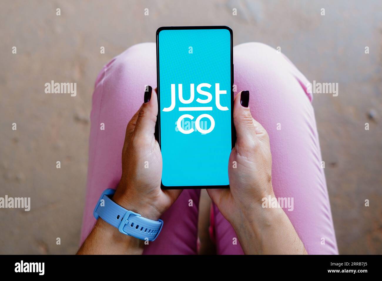 In this photo illustration, the JustCo logo is displayed on a smartphone screen Stock Photo - Alamy