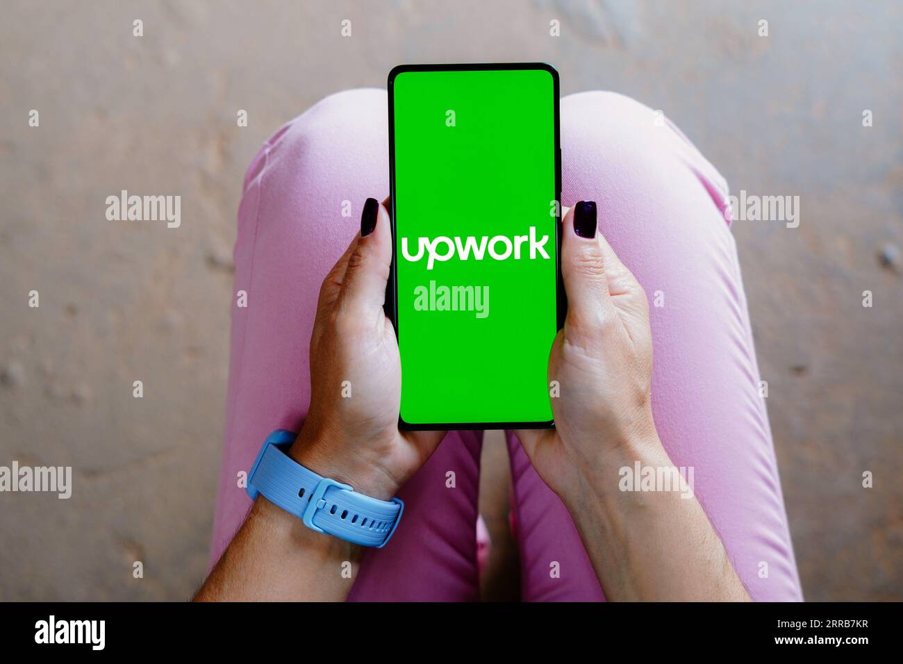 In this photo illustration, the Upwork logo is displayed on a ...