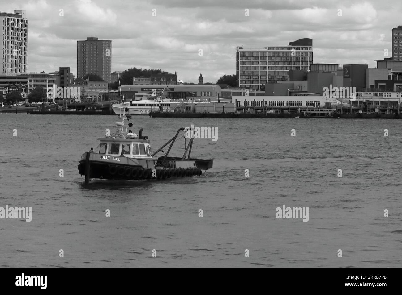 Black and white image of a dredger tug close to Gosport harbour. The ...