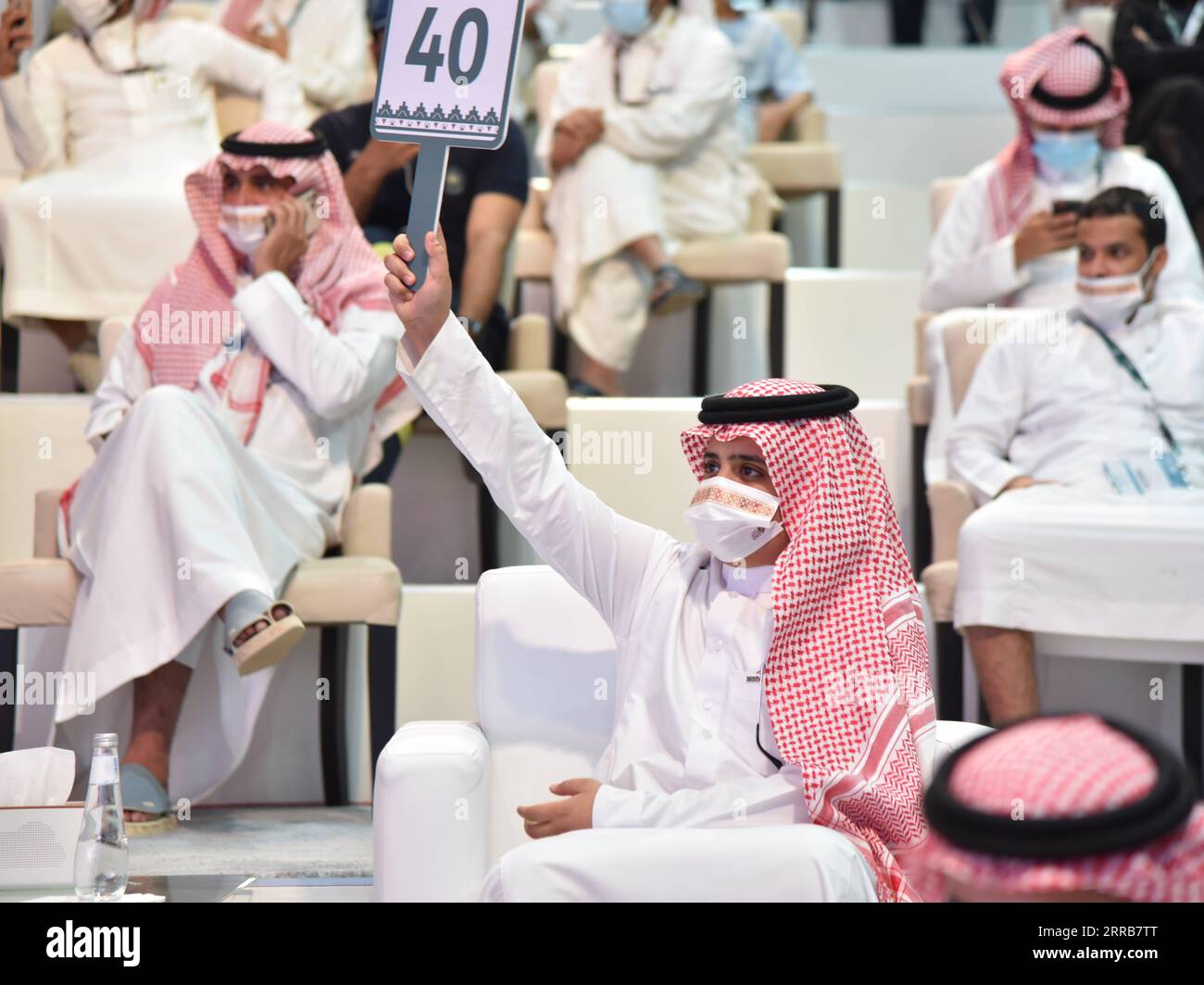 210906 -- RIYADH, Sept. 6, 2021 -- A man bids for a falcon during the ...