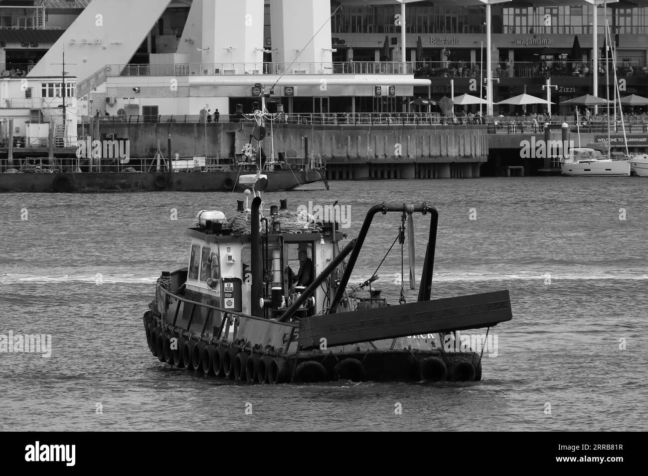 Black and white image of a dredger turning in the harbour. The Jolly ...