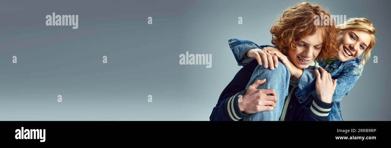 happy blonde teenage girl hugging stylish redhead boyfriend and smiling ...