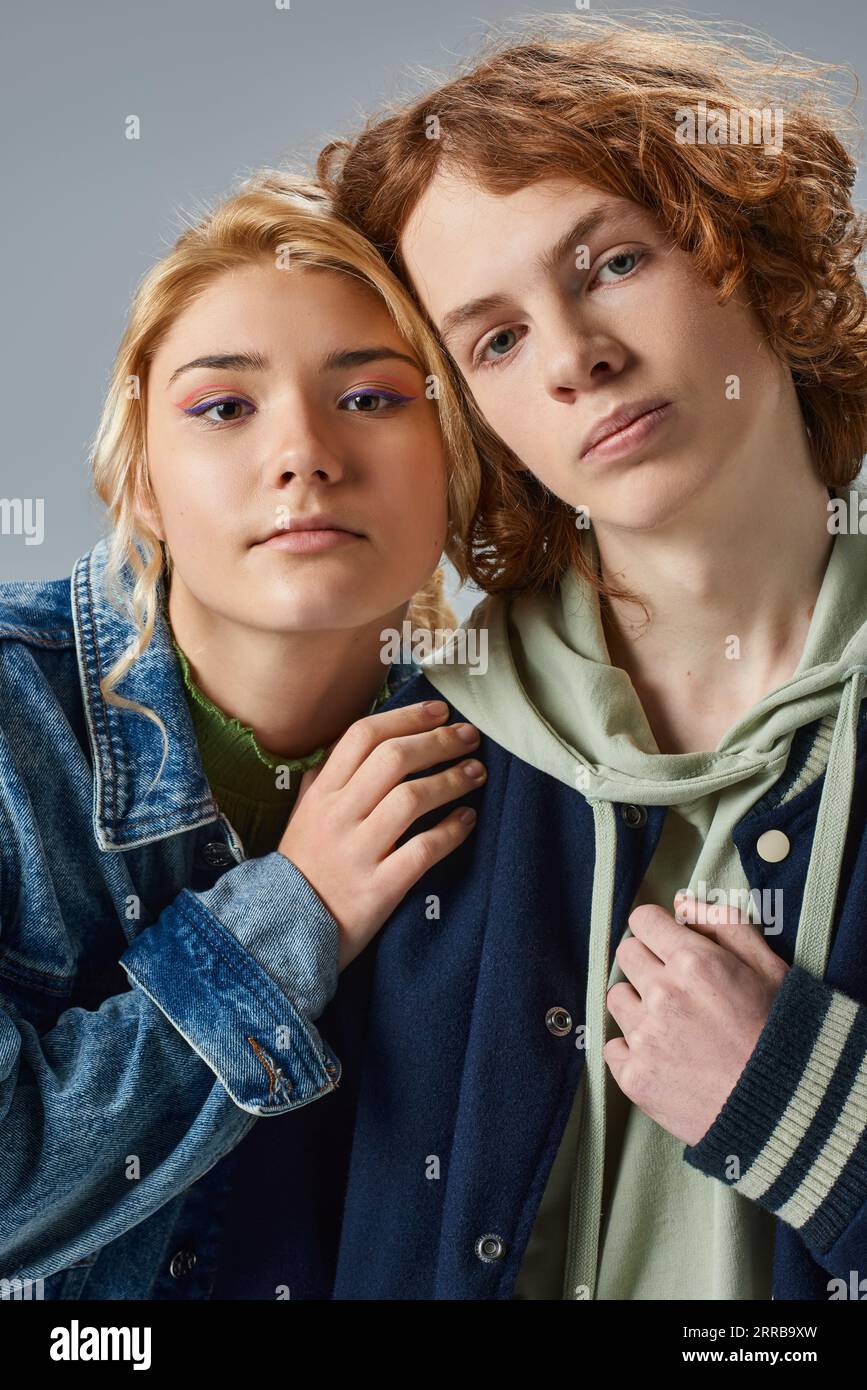 portrait of teenage models in trendy casual attire looking at camera on ...