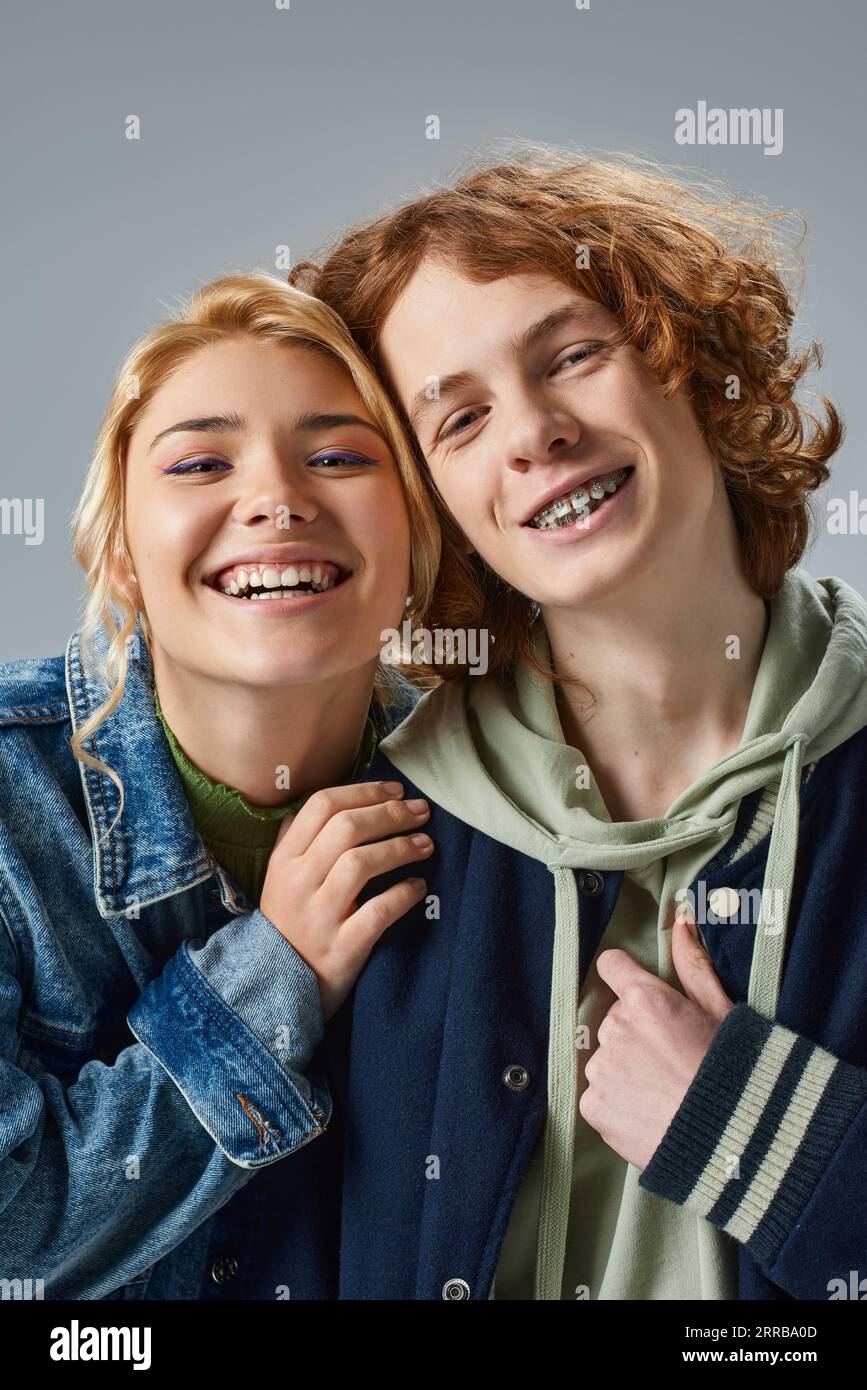 portrait of teenage friends in stylish casual outfit looking at camera ...