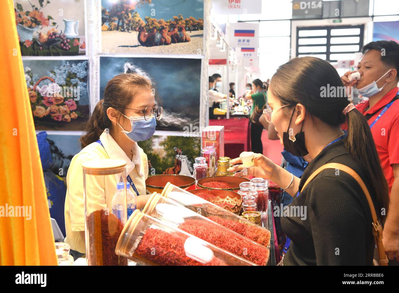 210912 -- NANNING, Sept. 12, 2021 -- A visitor tries products from Iran ...