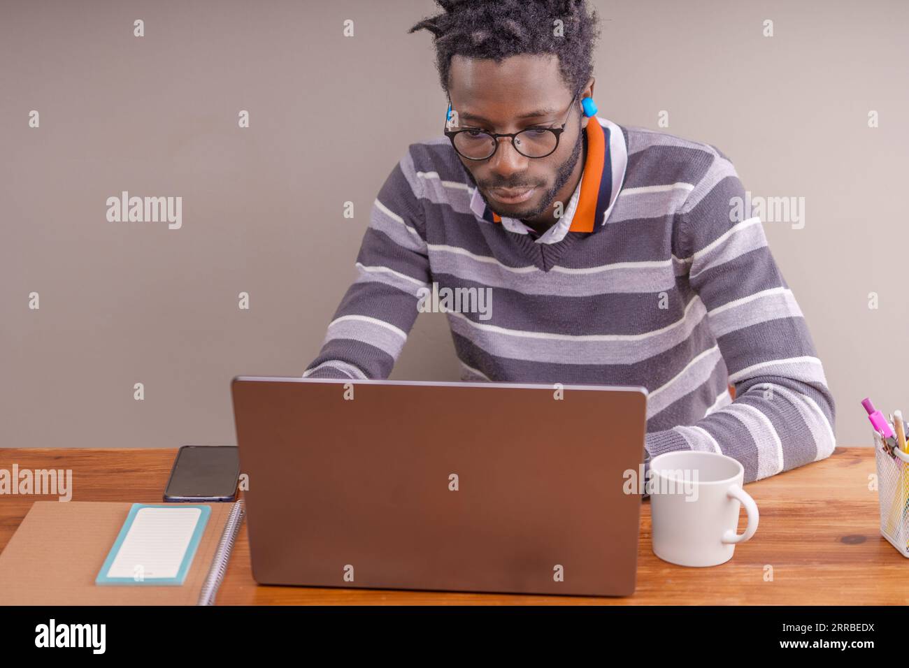 Afroamerican student with starter locs hairstyle, deeply engrossed ...