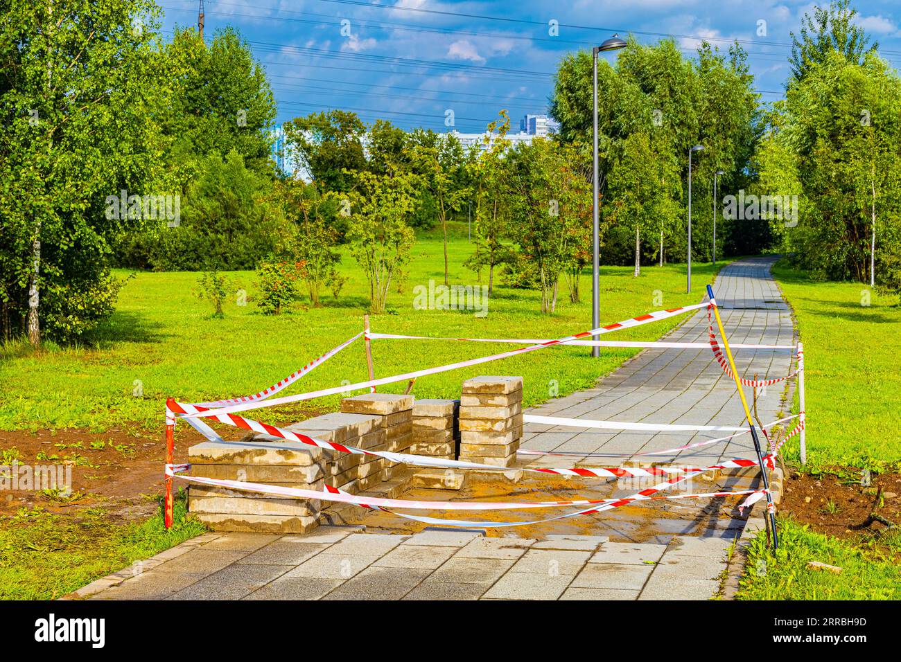 laying tiles on the path in the city park. tiling in the park. park ...