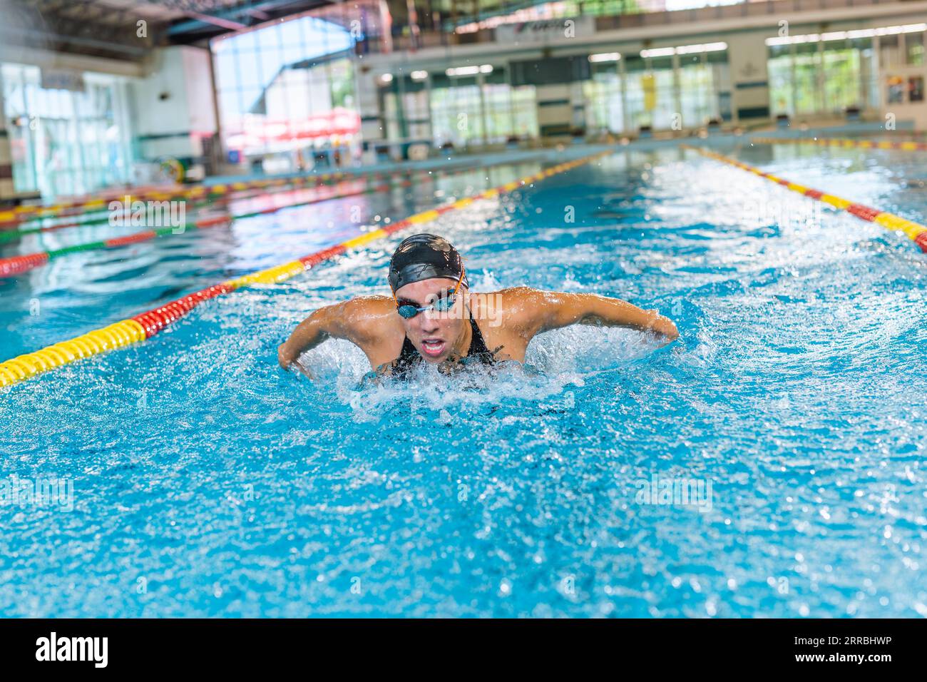 Well trained professional female swimmer in the butterfly stroke, arms ...