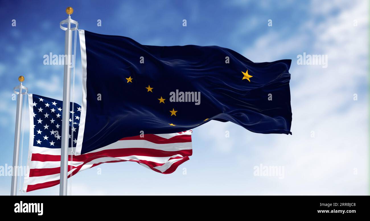 Alaska state flag waving in the wind with the national flag of the ...