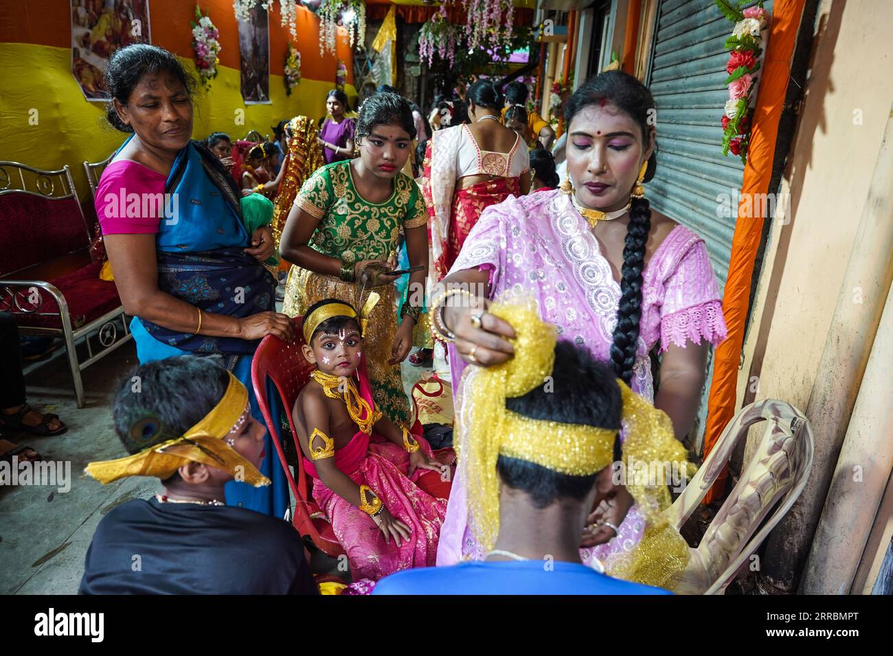 A lady prepares her children to look like lord Krishna during the ...