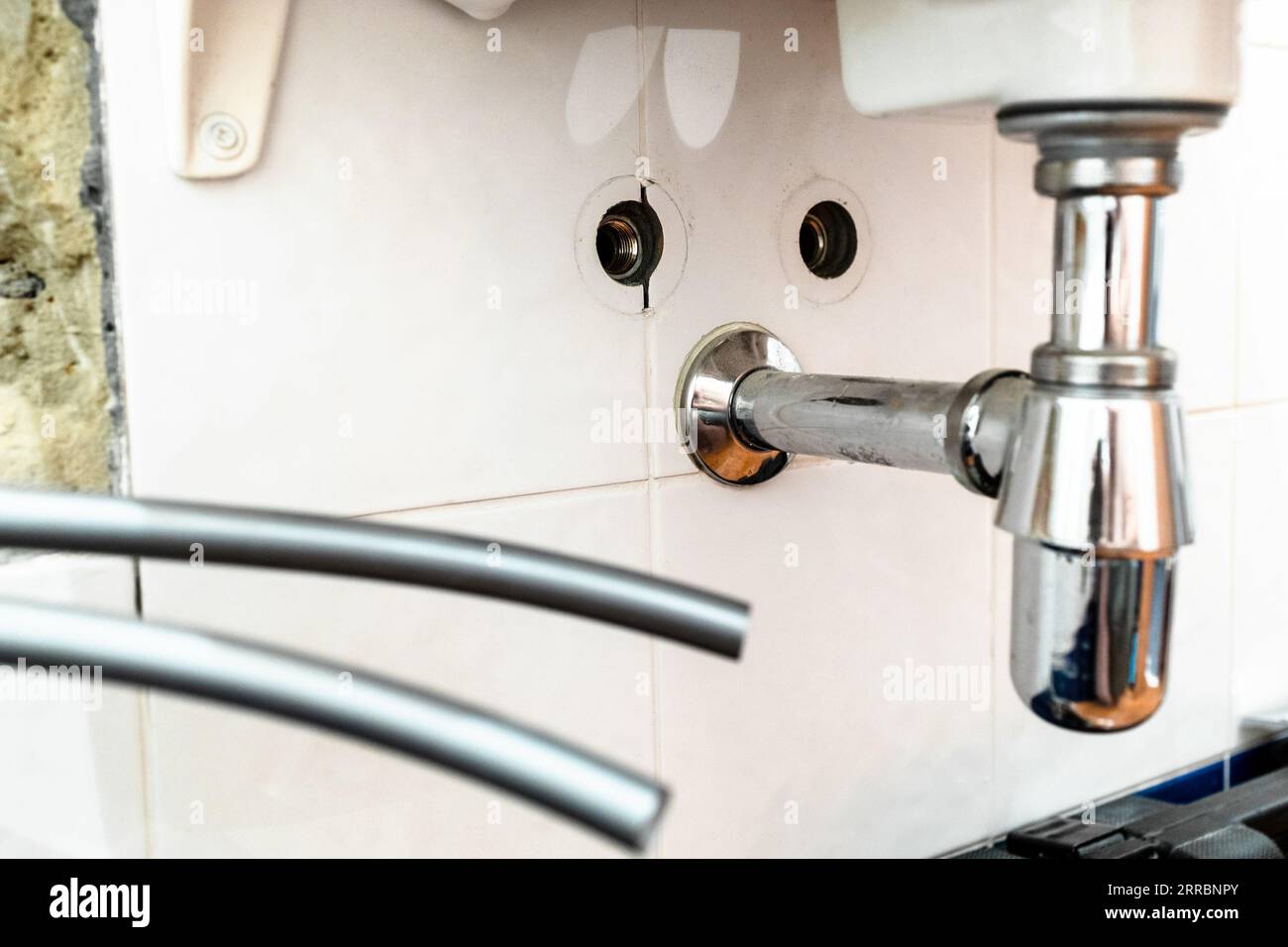 installation of new polyethylene flexible water pipes to faucet on sink ...