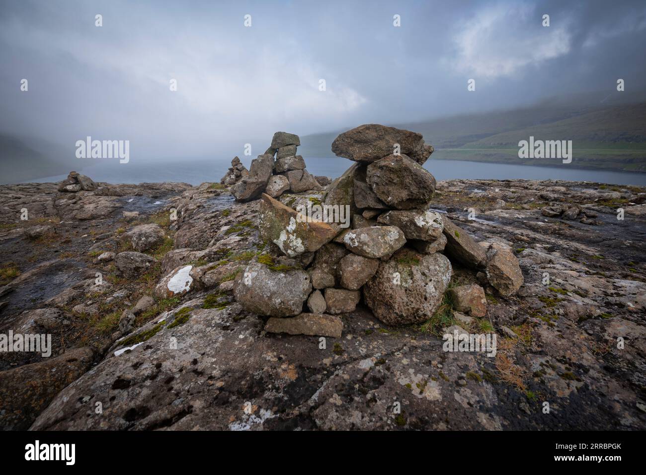 Rock cairns sit atop a stretch of open bedrock on Streymoy island in ...