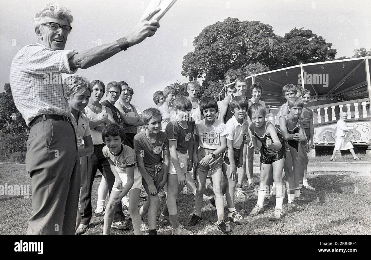 1981, outside in a field, a man holding up papes for the start of ...