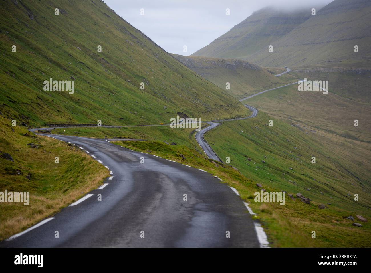 Lonely stretch of highway between valleys on Eysturoy island in the ...