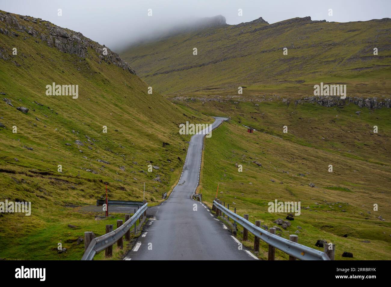 Lonely stretch of highway between valleys on Eysturoy island in the ...
