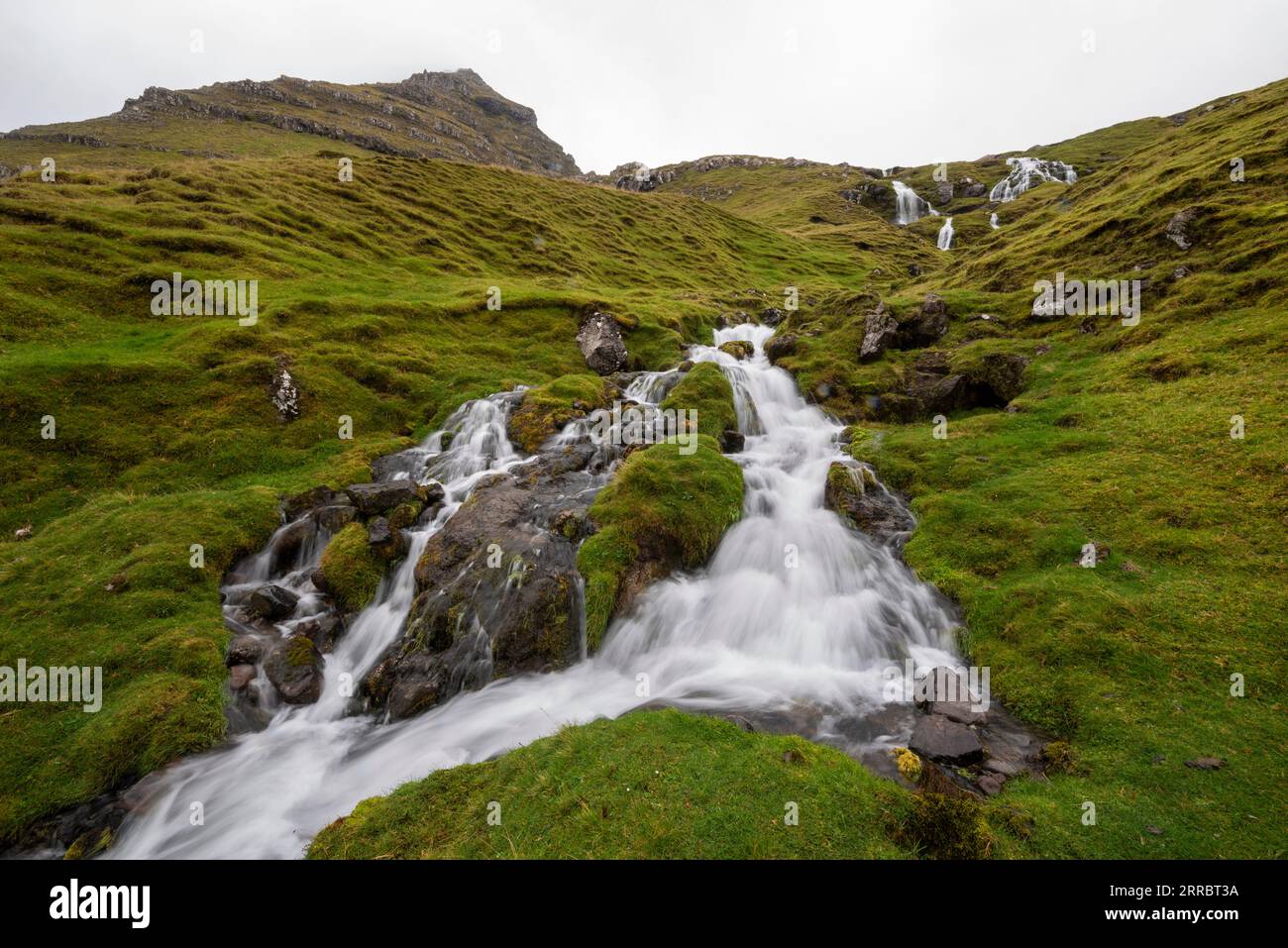 Water cascades down a steep mountainside on the northeast side of ...
