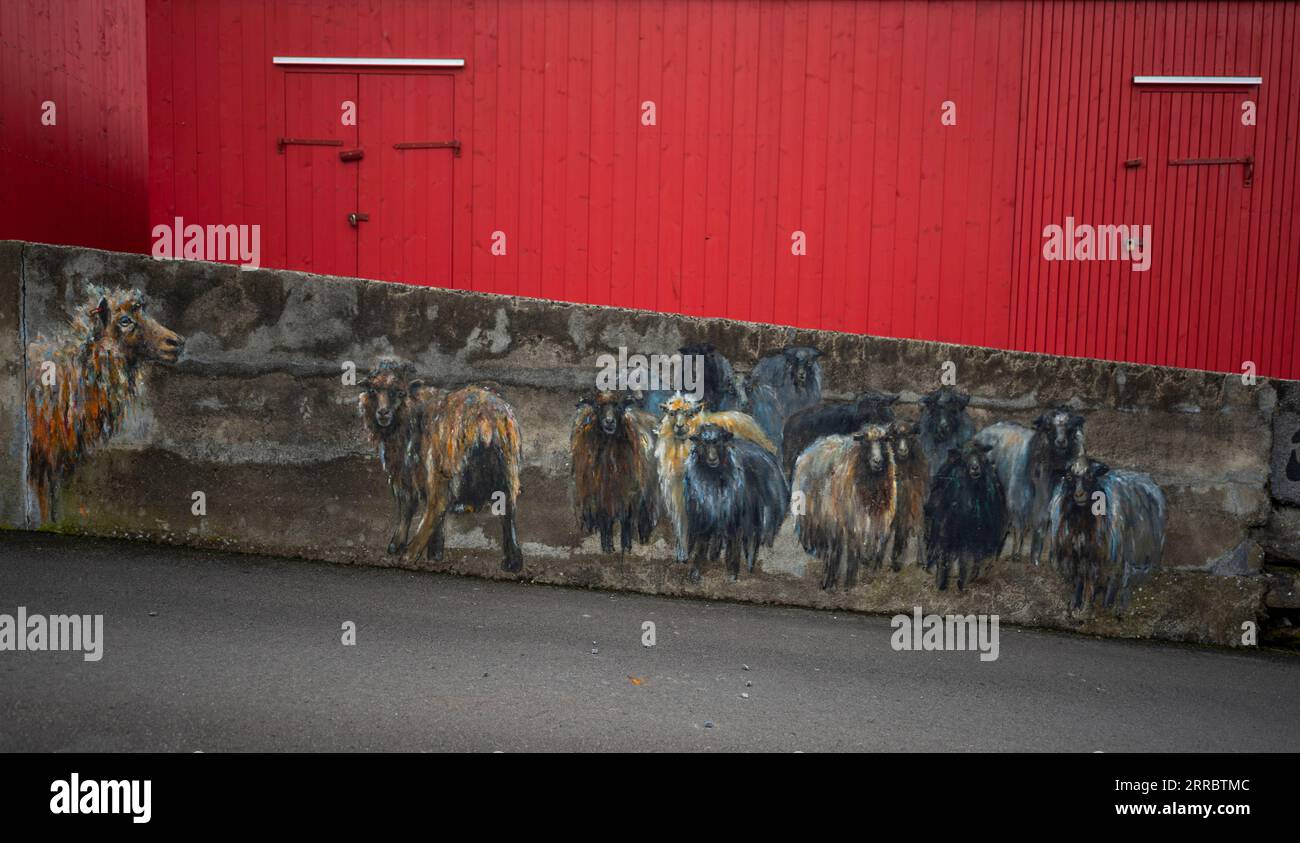 A playful mural of sheep adorn a wall in the village of Funningur on ...