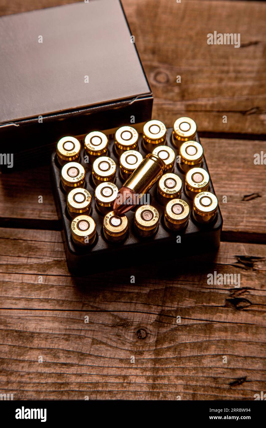 Pistol cartridges 9 mm on a wooden surface. Ammunition for pistols and ...