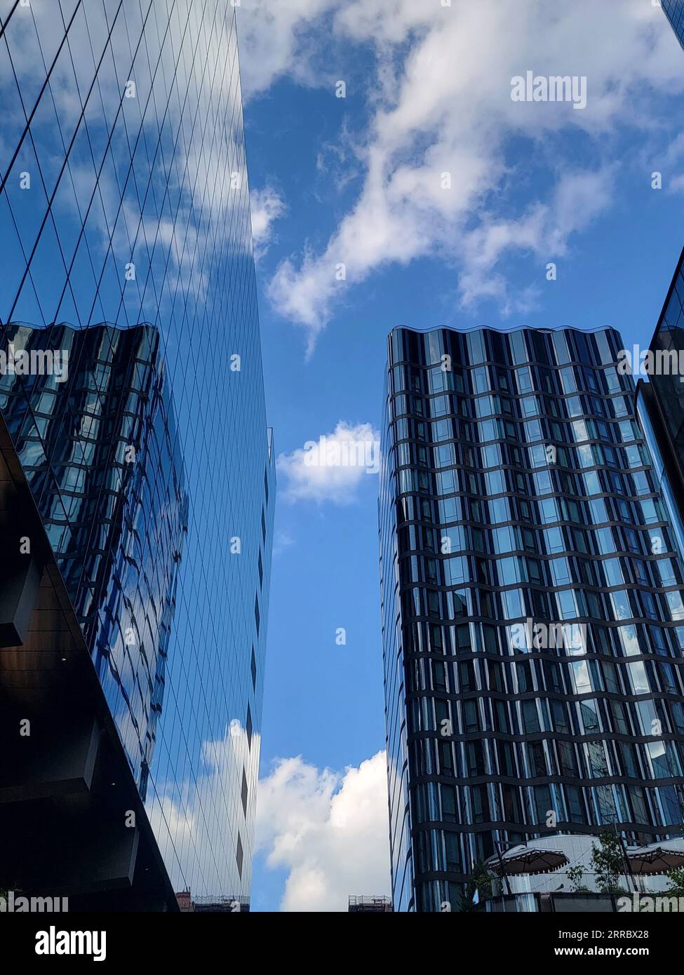 Blue sky over the reflected windows buildings Stock Photo - Alamy