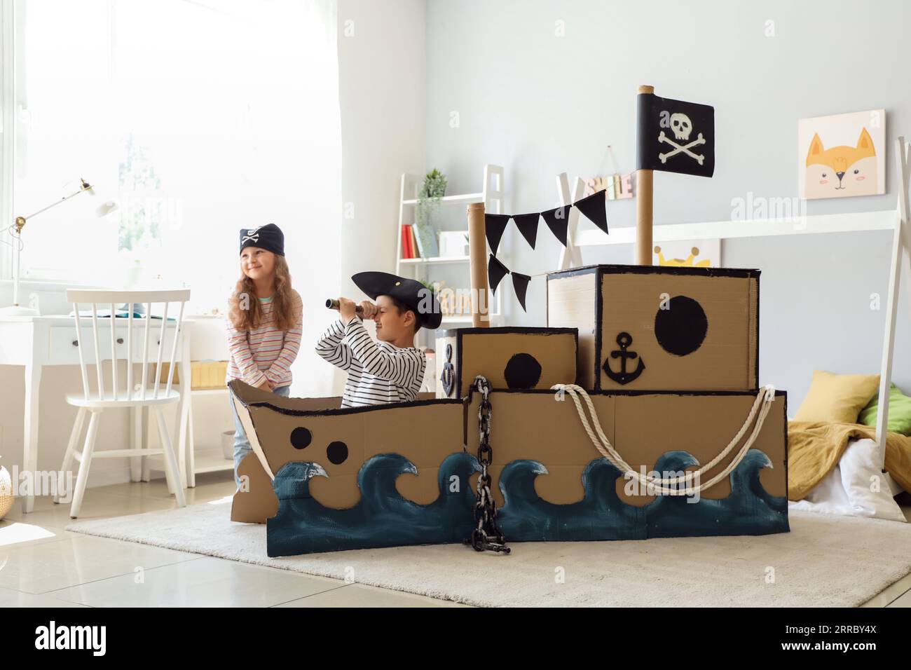 Cute little pirates playing in cardboard ship at home Stock Photo - Alamy