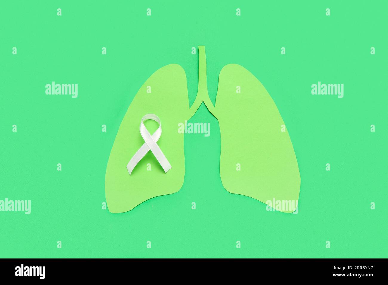 Paper lungs, cigarettes and white ribbon on green background. Lung ...