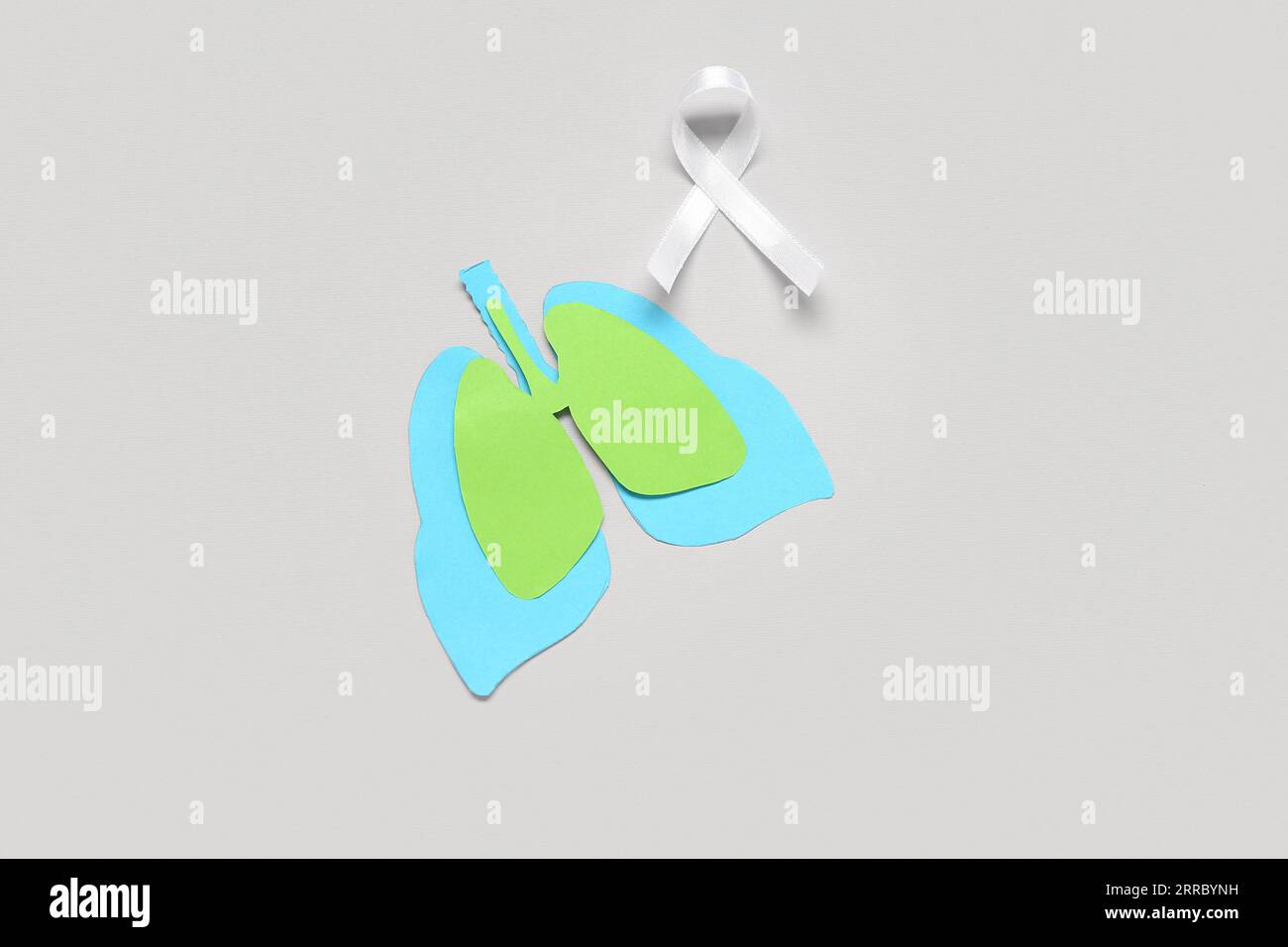 Paper lungs with white ribbon on grey background. Lung cancer concept ...