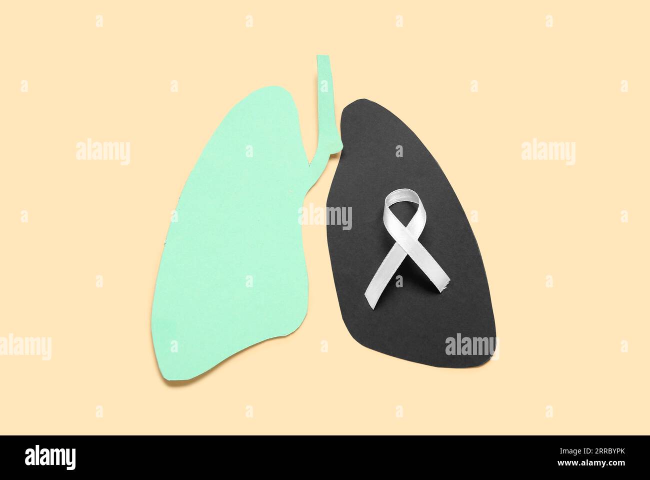 Diseased paper lungs with white ribbon on beige background. Lung cancer ...