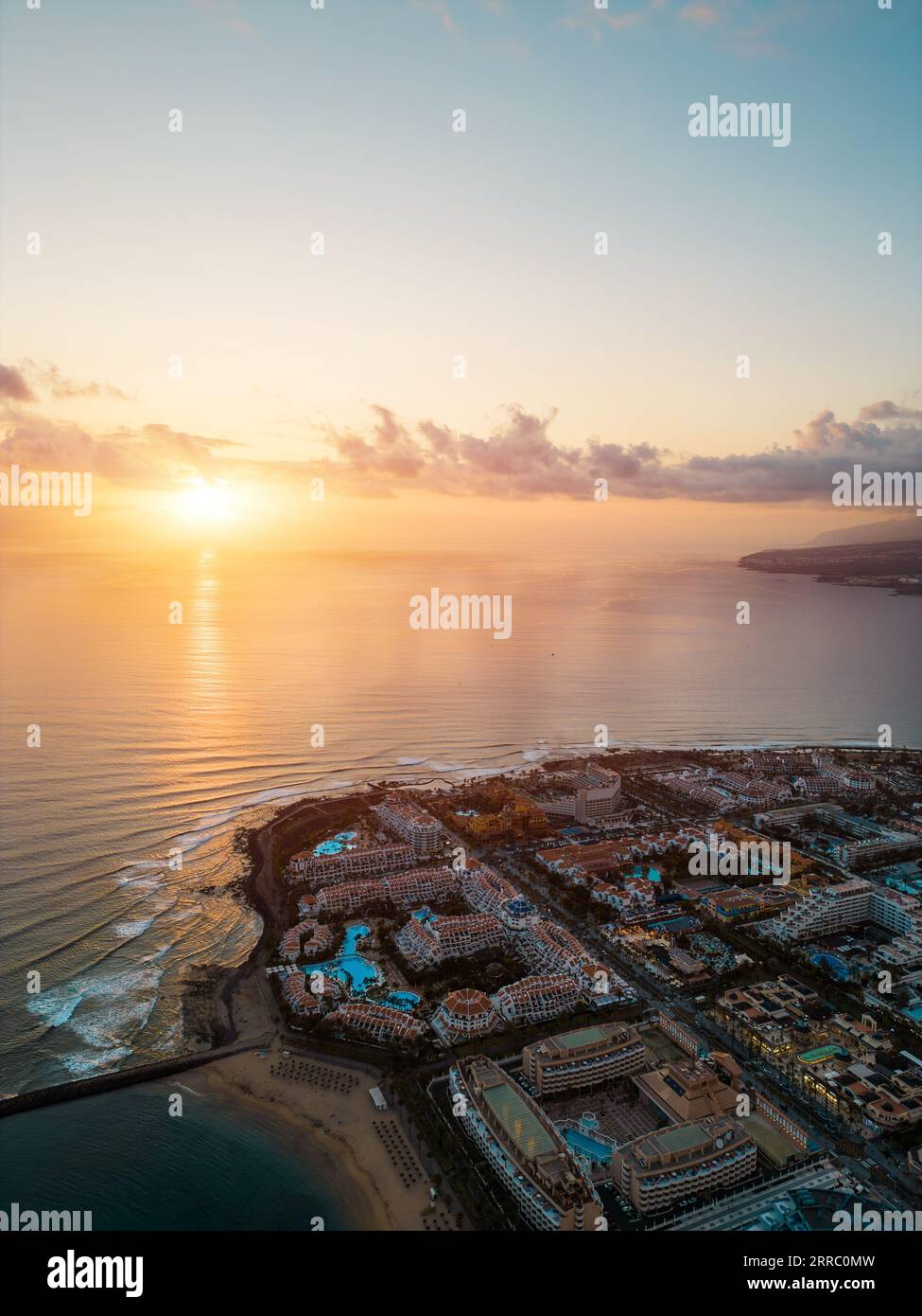 sunset at ocean shore with hotels and villas of Tenerife, Canary island ...