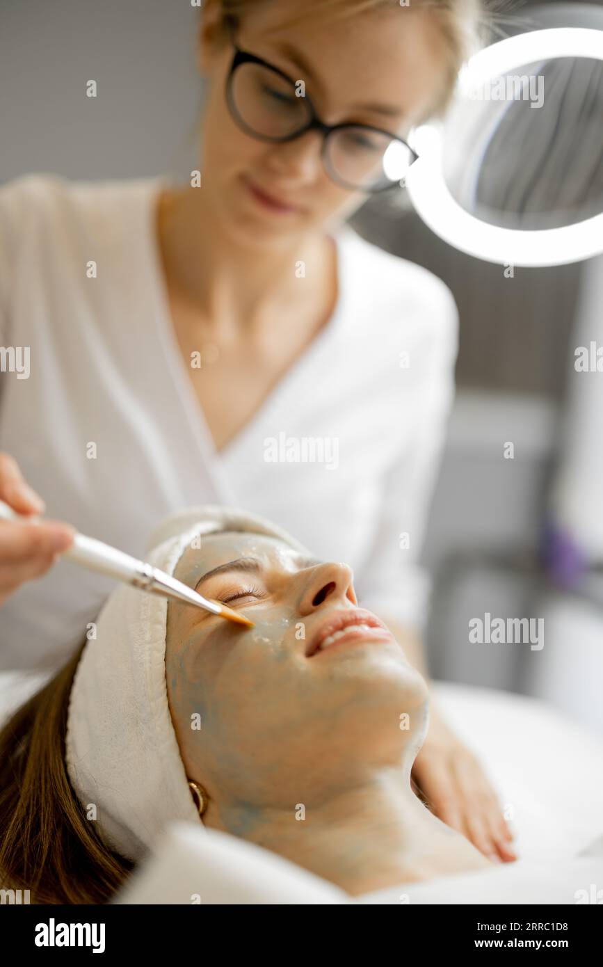 Female cosmetologist applies cream hi-res stock photography and images ...