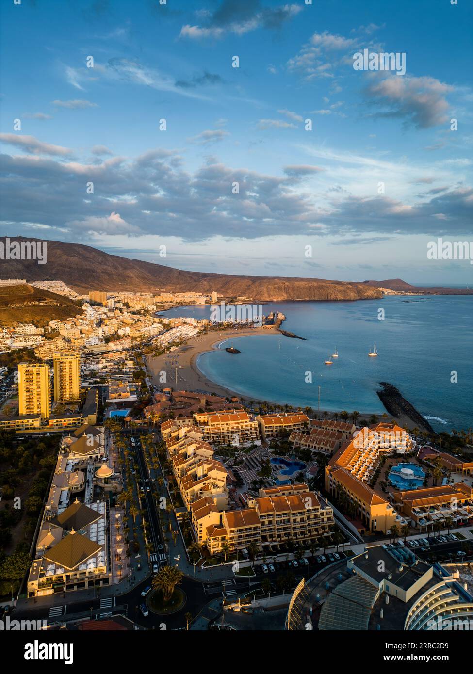 sunset at ocean shore with hotels and villas of Tenerife, Canary island ...