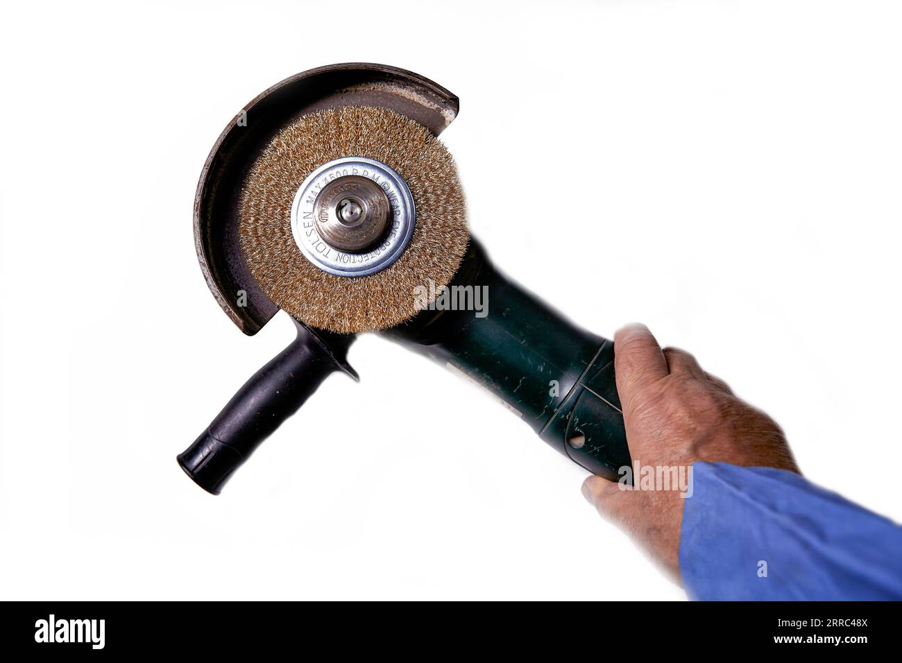 Round wire brush in the electric grinder tool and people's hand ...