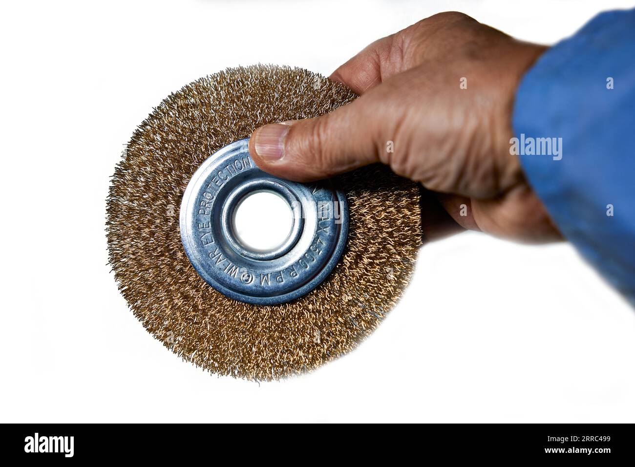 Round wire brush in the people's hand. Insolated on white background ...