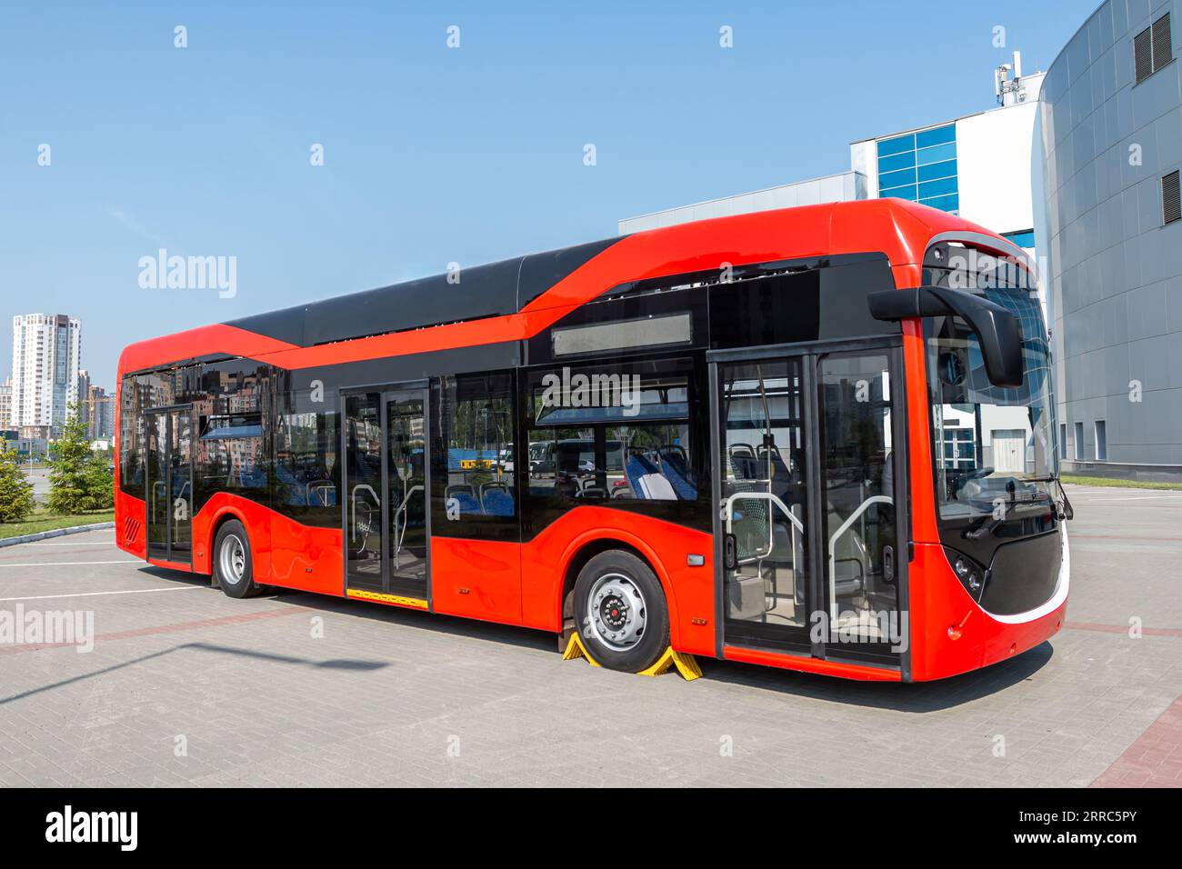 Red modern city bus at the bus station on a clear day Stock Photo - Alamy