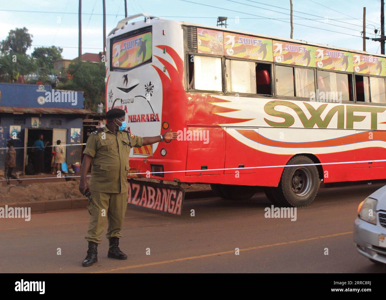 211025 -- MPIGI UGANDA, Oct. 25, 2021 -- A police officer stands guard ...