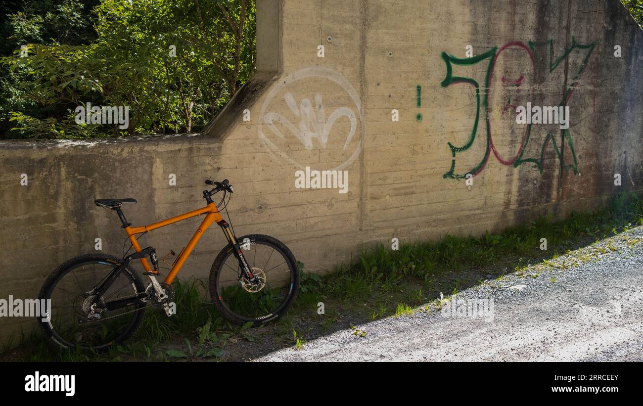 Bike on cement wall Stock Photo - Alamy