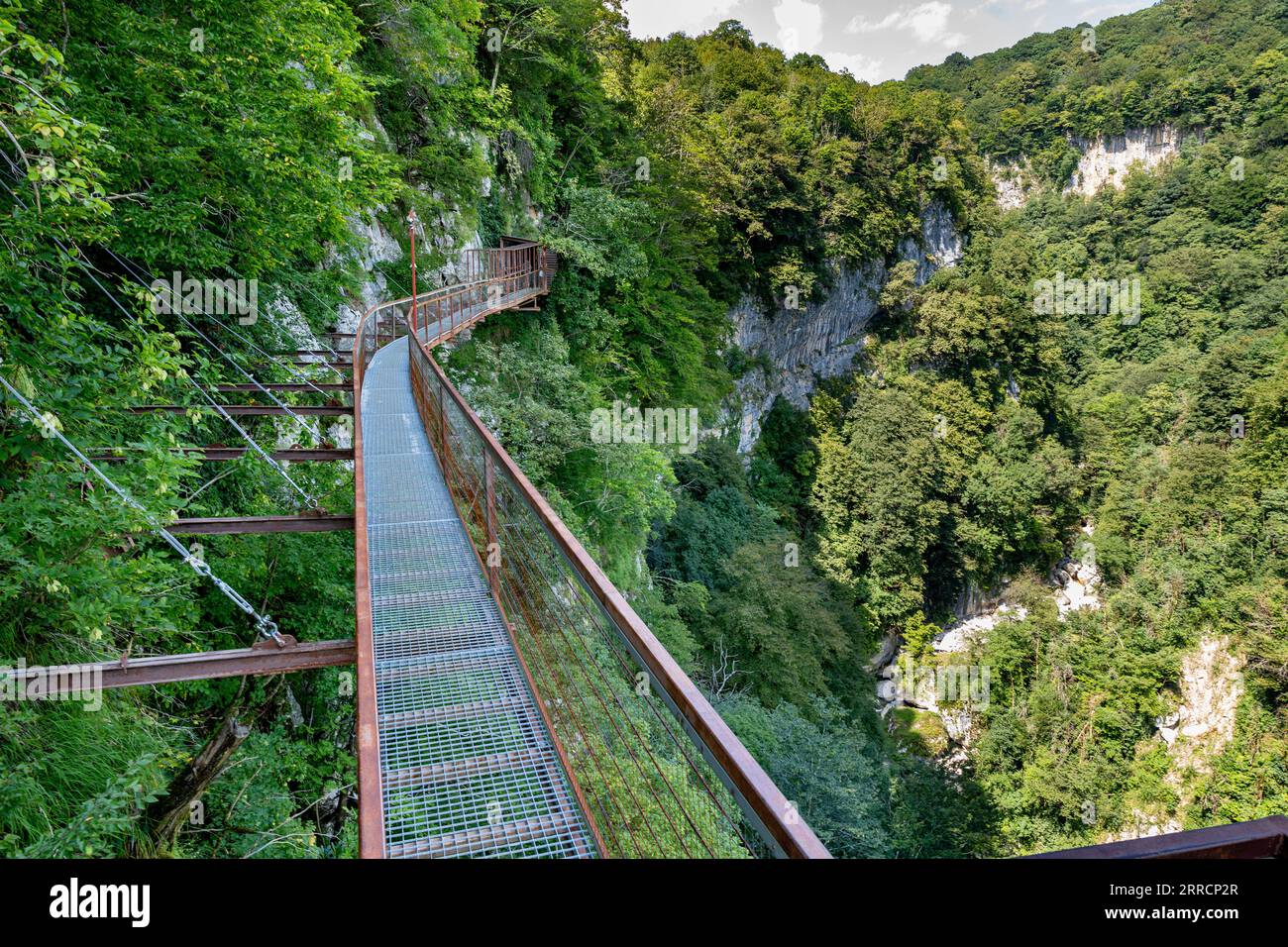 Hanging metal walking bridge trail in mountain canyon in Georgia Stock ...