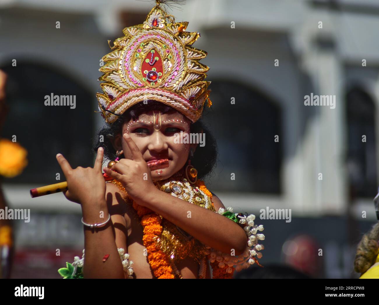 A young Hindu boy, dressed as Lord Krishna, take part in the Hindu religious procession to mark ...